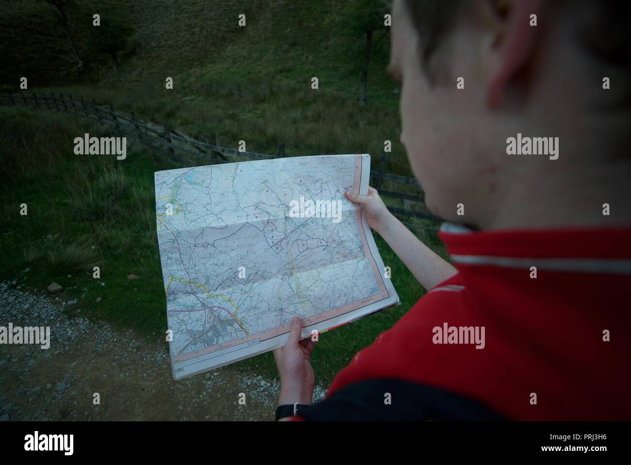 Man reading a map whilst hiking in the Peak District. Map-reading ...