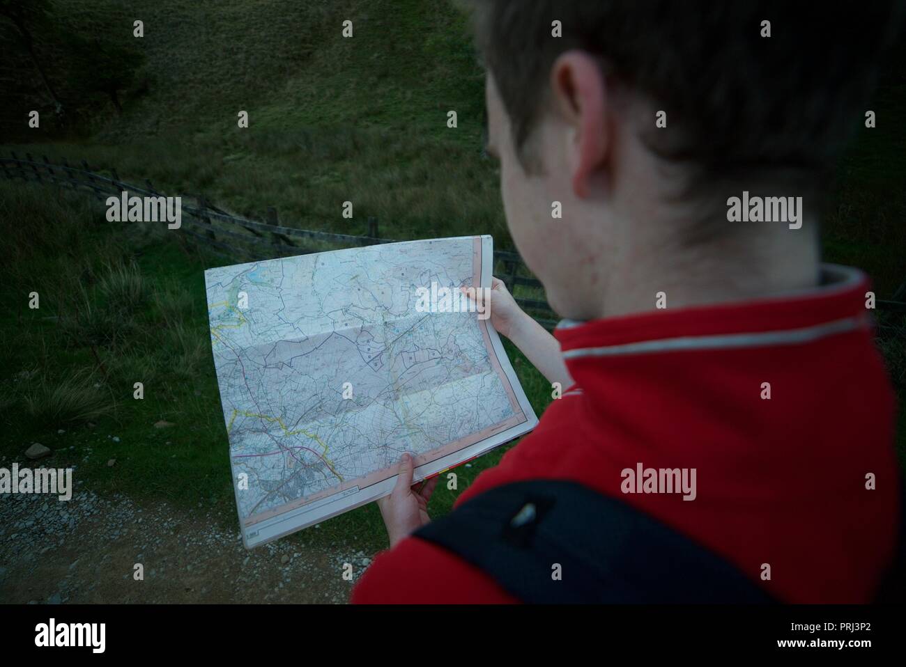 Man reading a map whilst hiking in the Peak District. Map-reading ...
