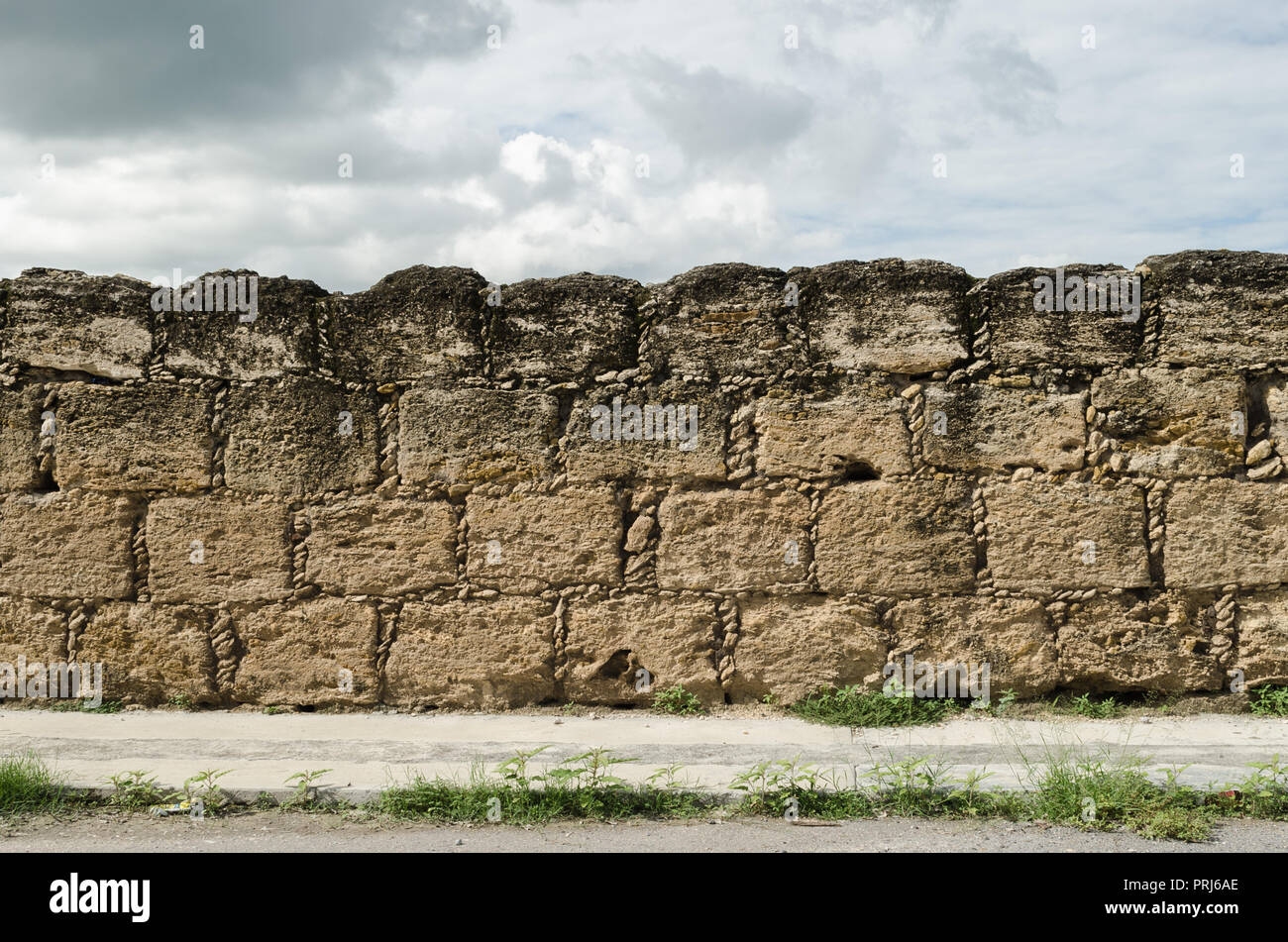wall of large broken stones dusty and rusty, wall on the sidewalk that ...
