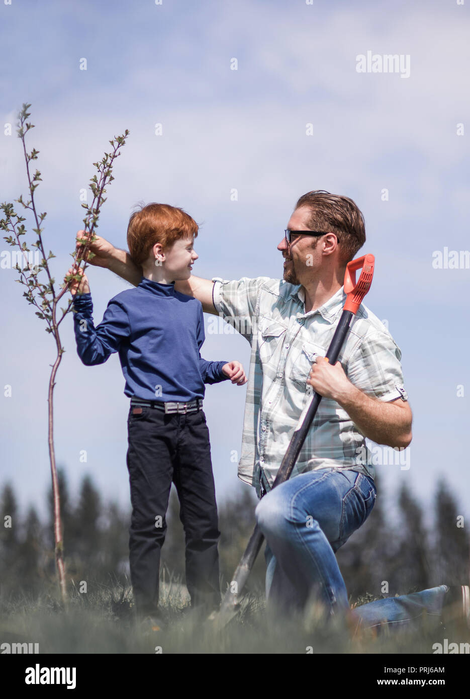 happy father and son planted a tree together Stock Photo - Alamy