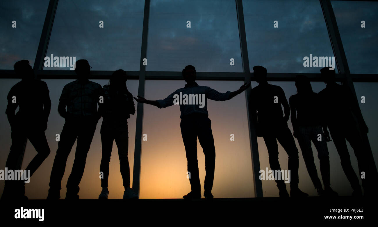 leader and the business team on background of office window Stock Photo ...