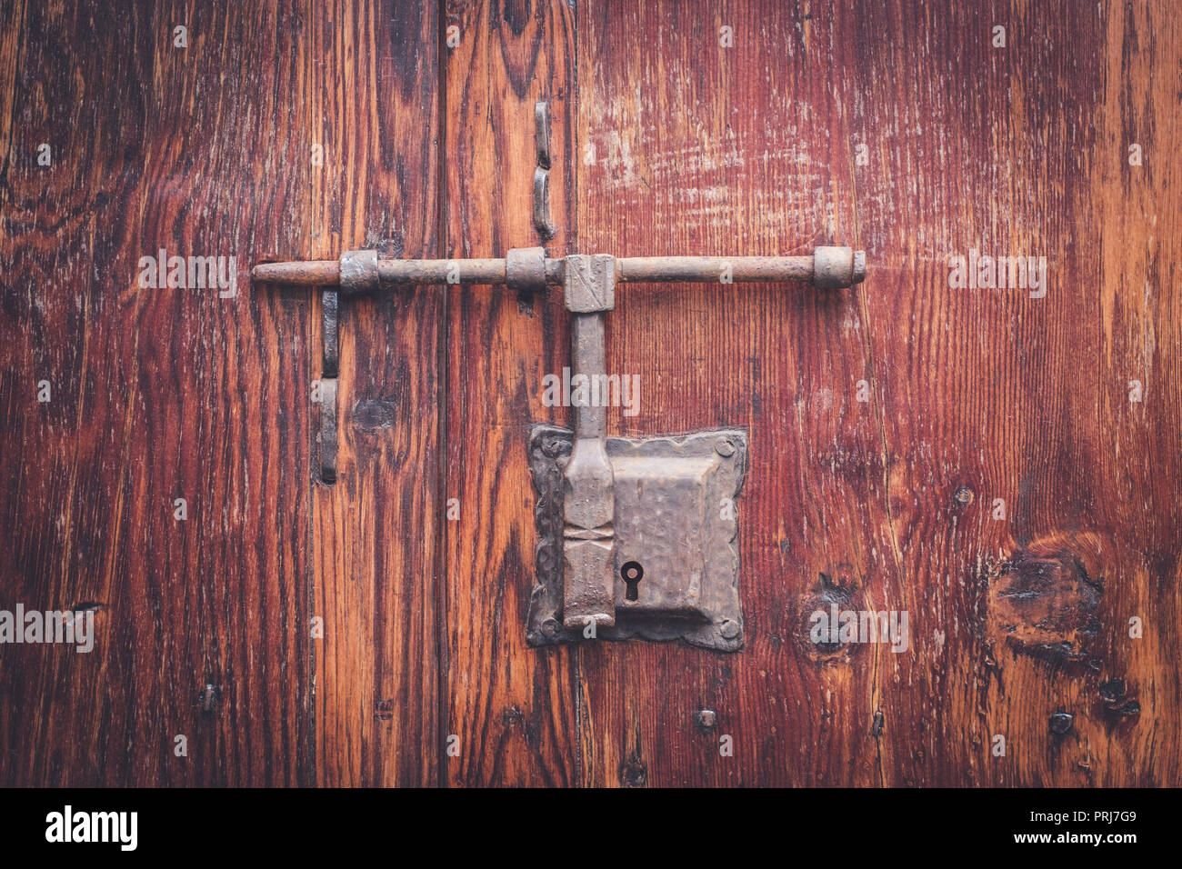 old wooden door locked with metal bar / bolt Stock Photo - Alamy