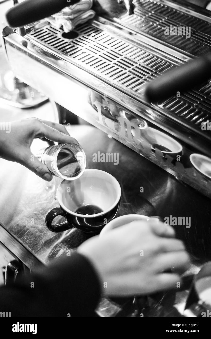 making espresso coffee BW black and white close up detail with modern ...