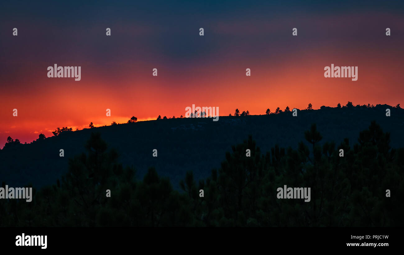 Sunset after the mountains, like fire flames Stock Photo - Alamy