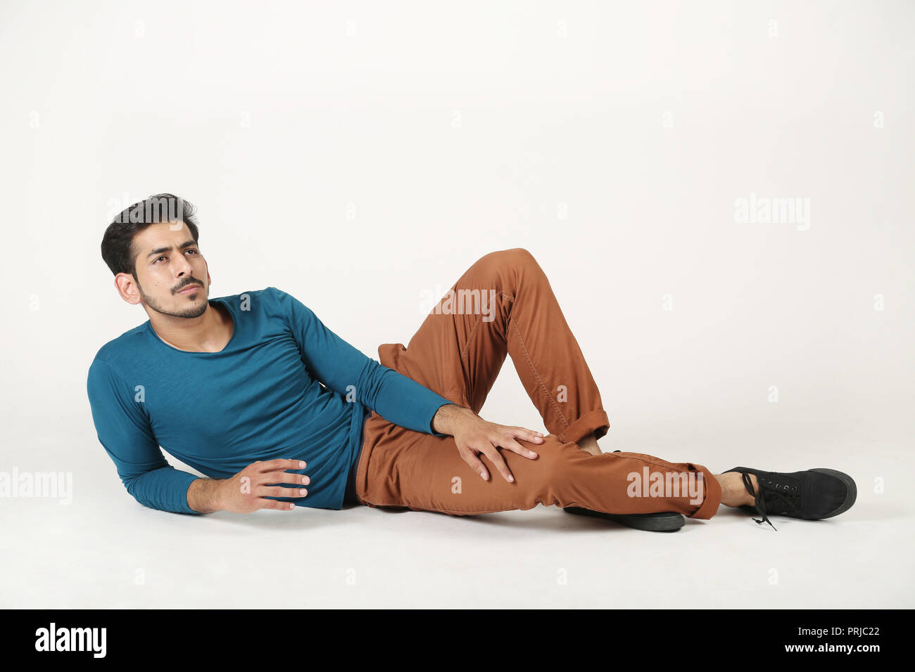 Indian smart boy is relaxing on white background Stock Photo - Alamy