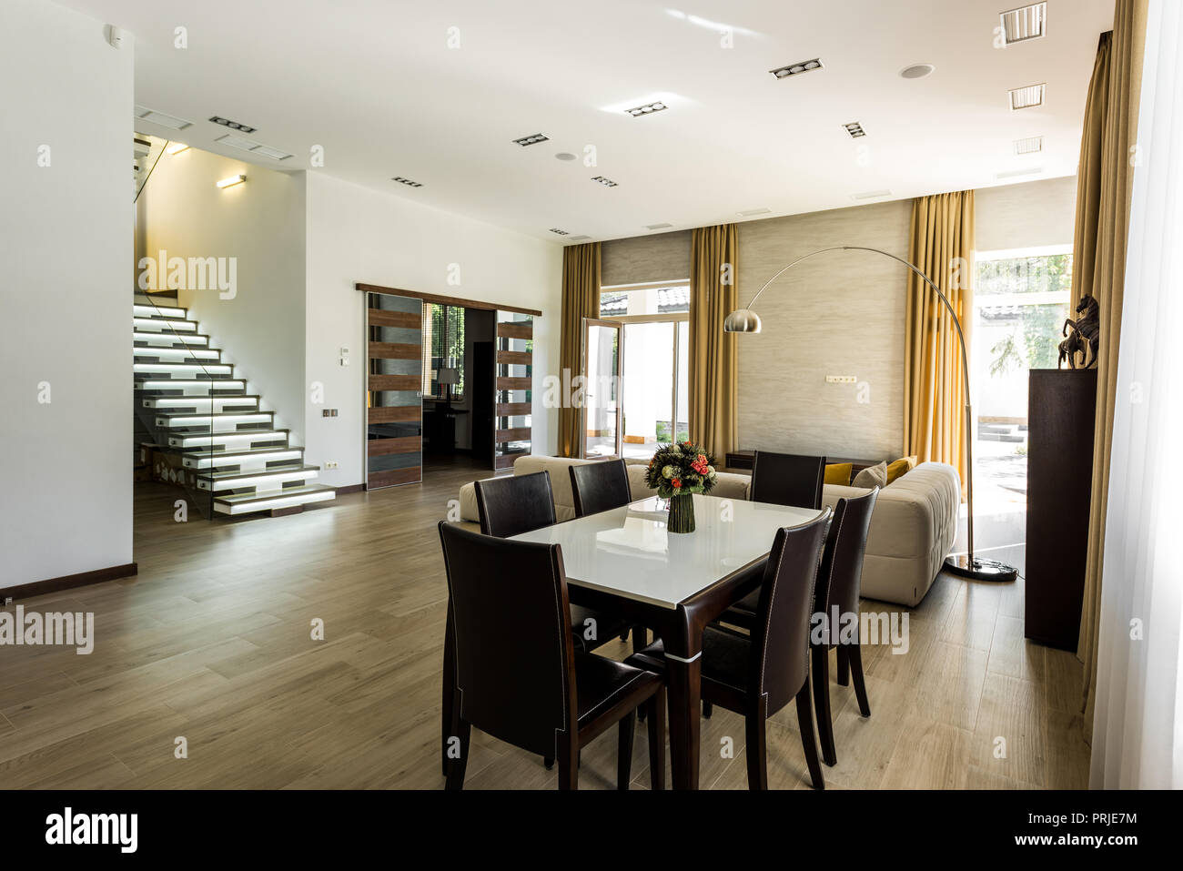 interior view of empty dining room with table, chairs and stairs Stock ...