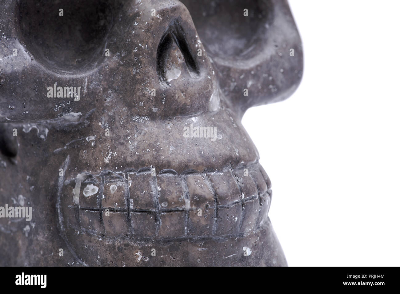 Grey volcanic rock carved skull isolated on white background Stock ...