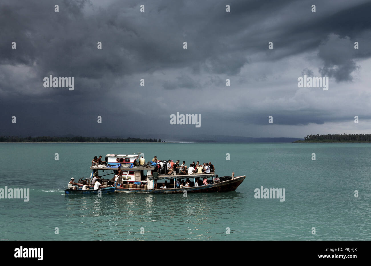 Overloaded wooden ferry off the coast of Nias Island in Sumatra ...