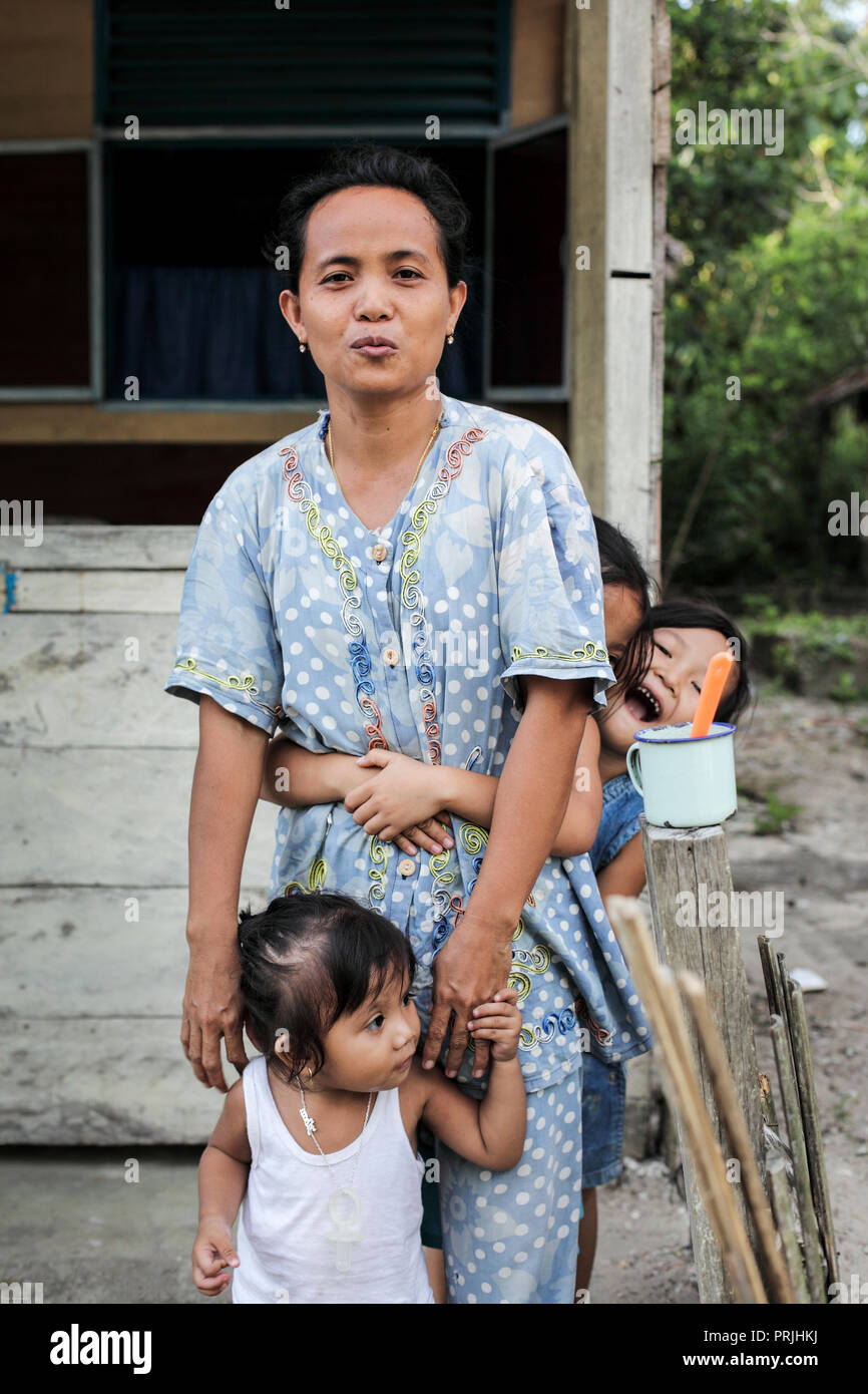 Woman and her children in the village of Afulu on Nias Island, Sumatra ...