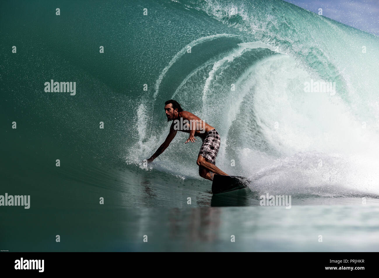 Surfer riding inside tube of green wave on Nias Island, Sumatra ...