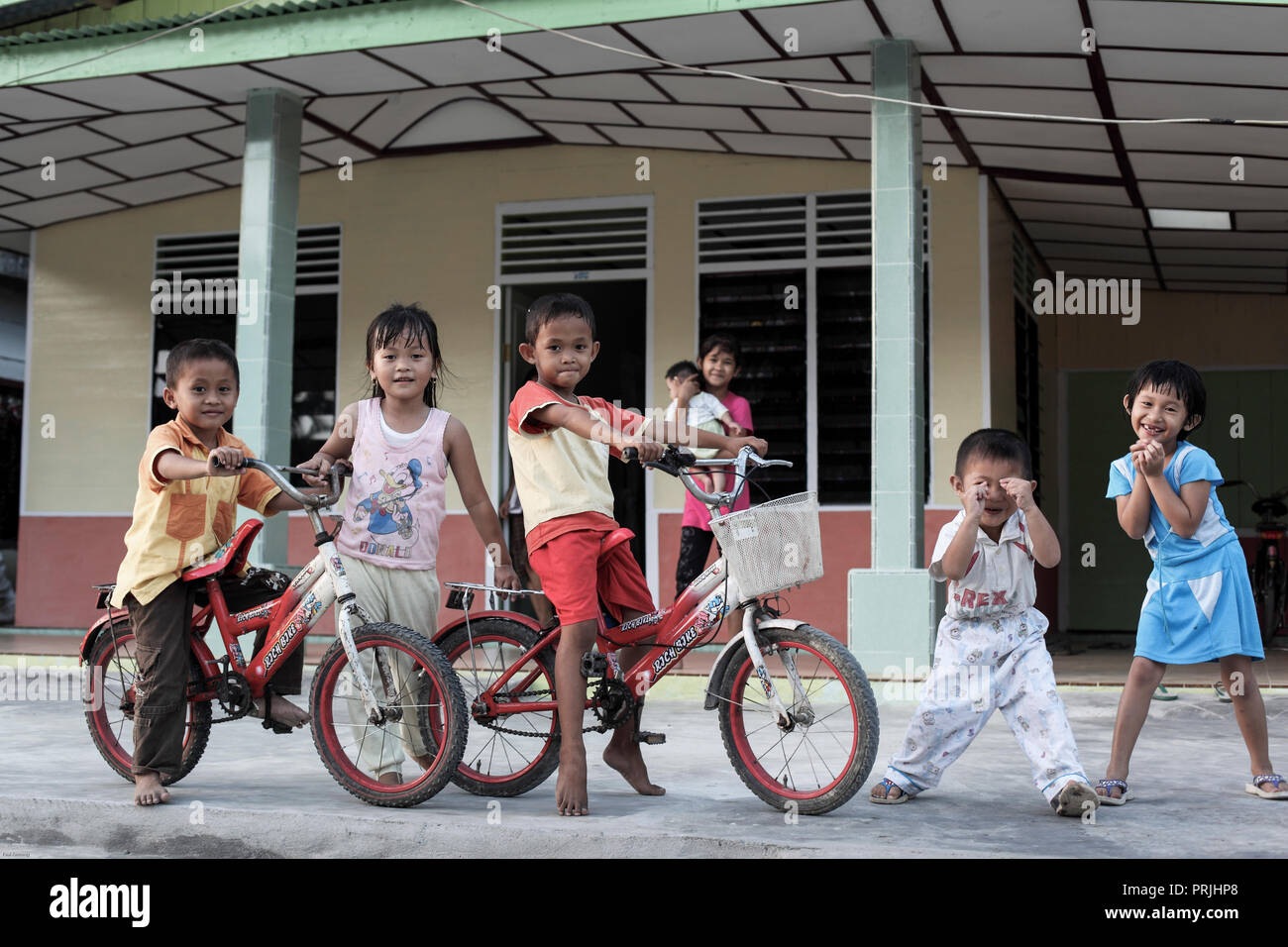 Happy children posing for a photo at Afulu village on Nias Island ...