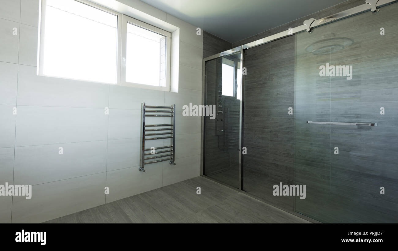 interior of empty bathroom with glass shower in grey color Stock Photo ...