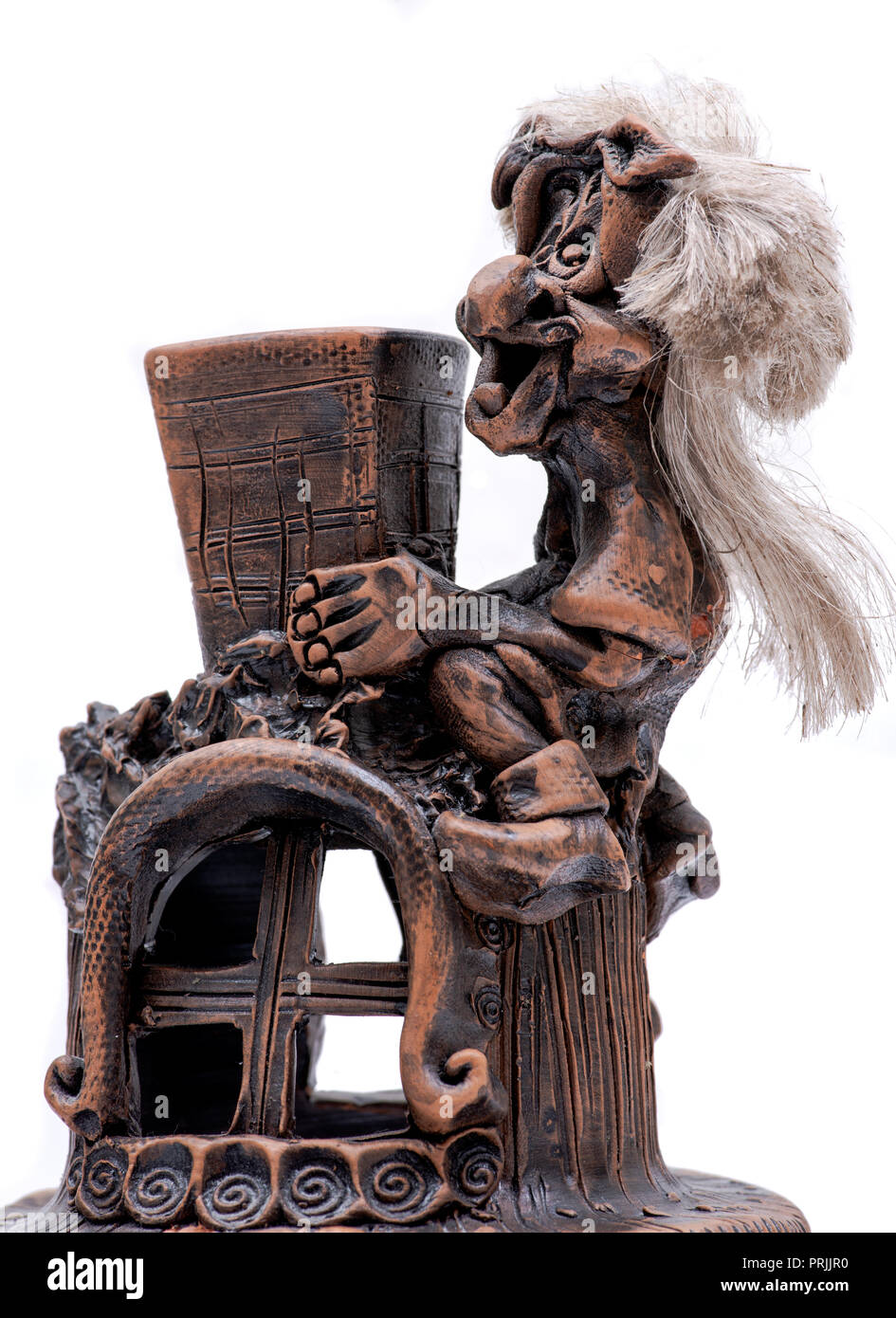 Old smiling witch sitting on the chimney isolated on white background ...