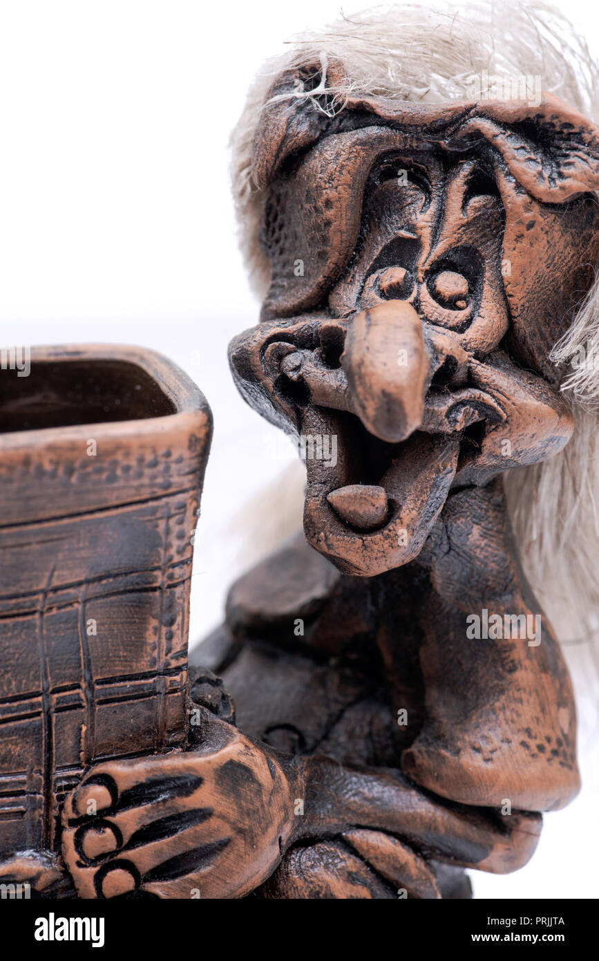 Old smiling witch sitting on the chimney isolated on white background ...