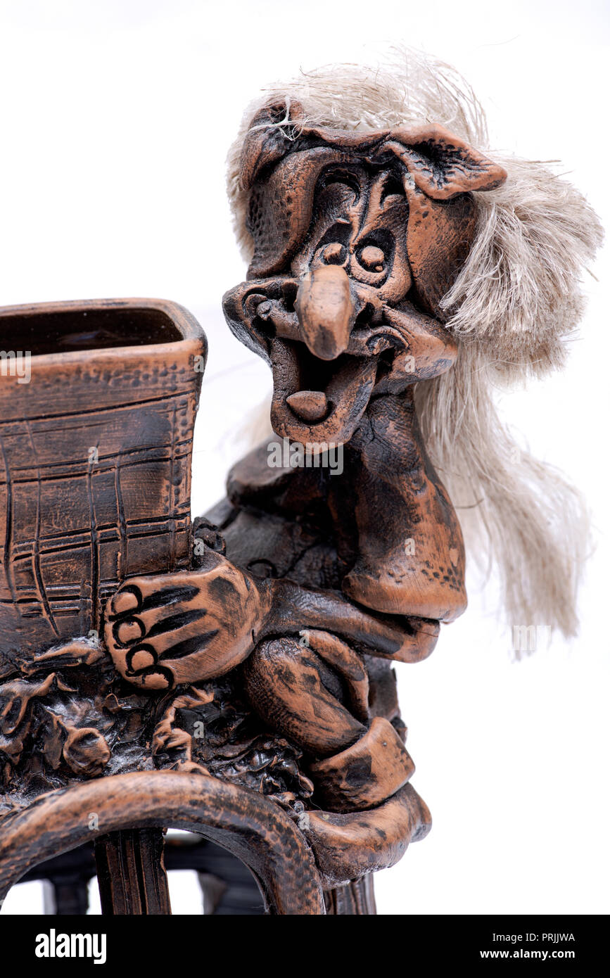 Old smiling witch sitting on the chimney isolated on white background ...
