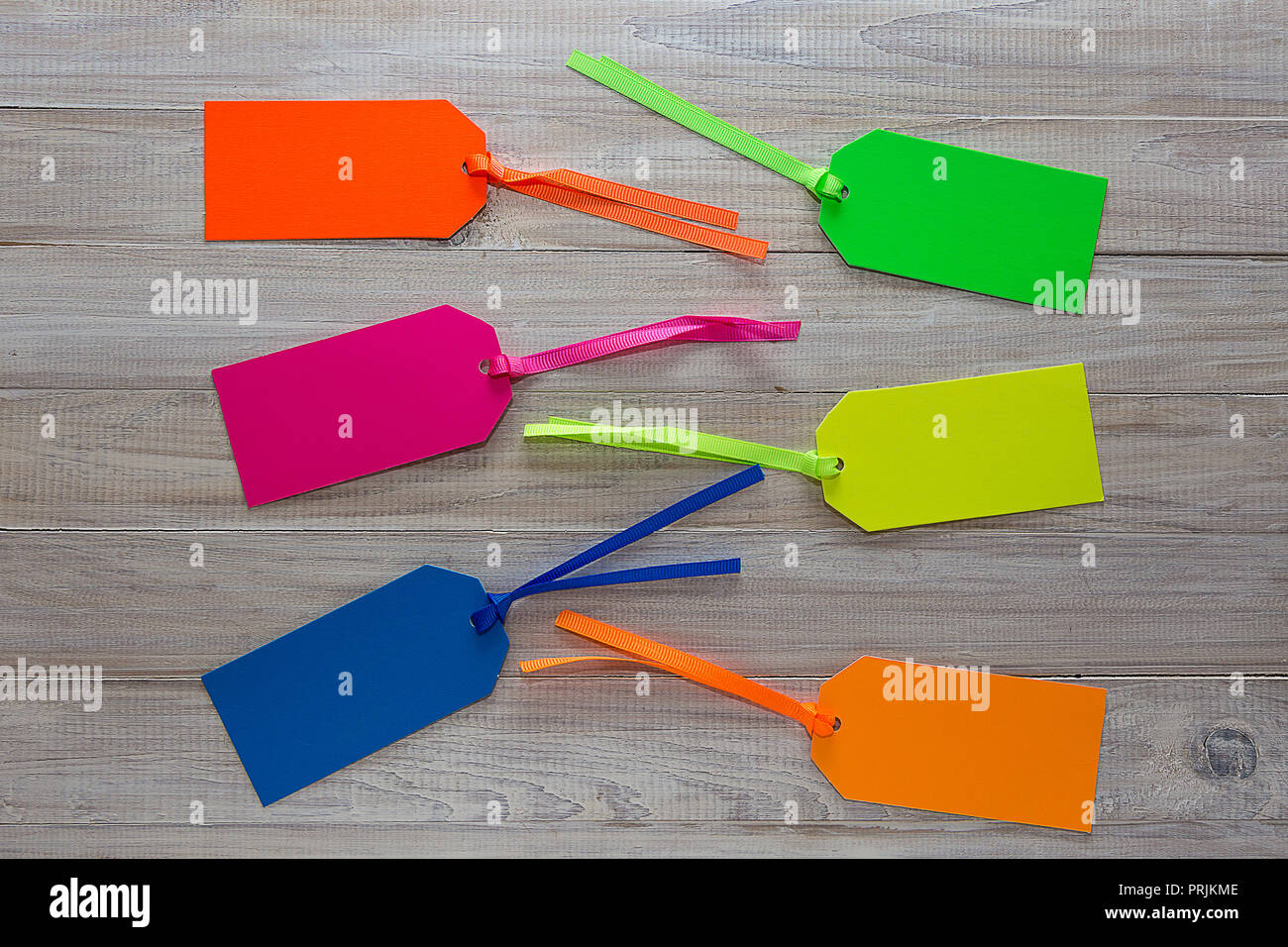 Six Colorful Paperboard Tags on a Wooden Background Stock Photo - Alamy