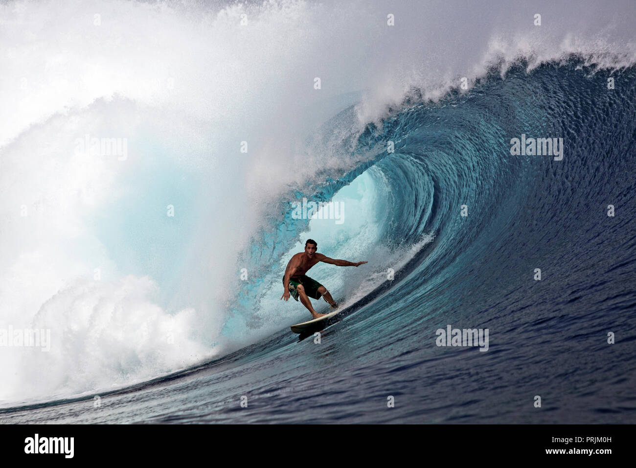 Surfing a large blue reef wave in the Mentawai Islands, Sumatra ...