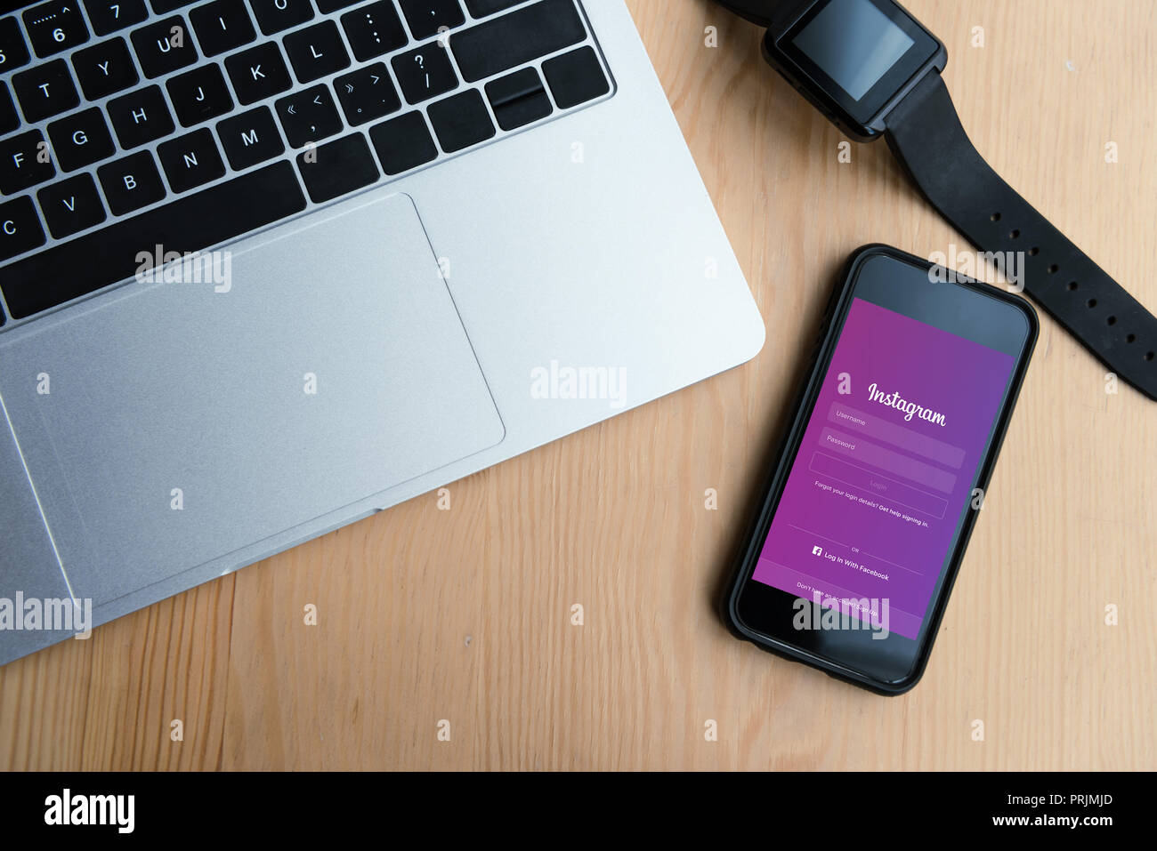 top view of laptop, smartwatch and smartphone with instagram website on ...