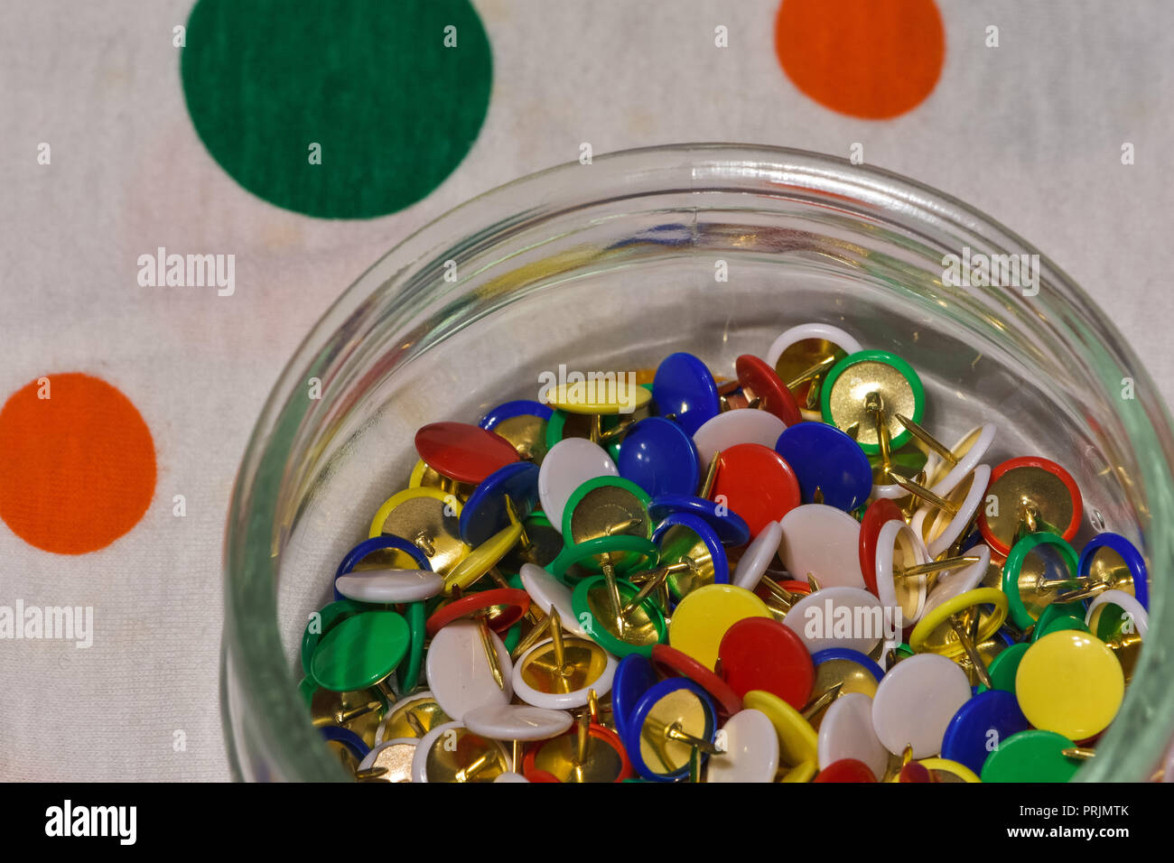 colored thumbtacks in a glass jar, horizontal image Stock Photo - Alamy