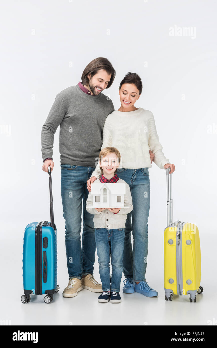 happy boy holding carton house ready to move with his family into new ...