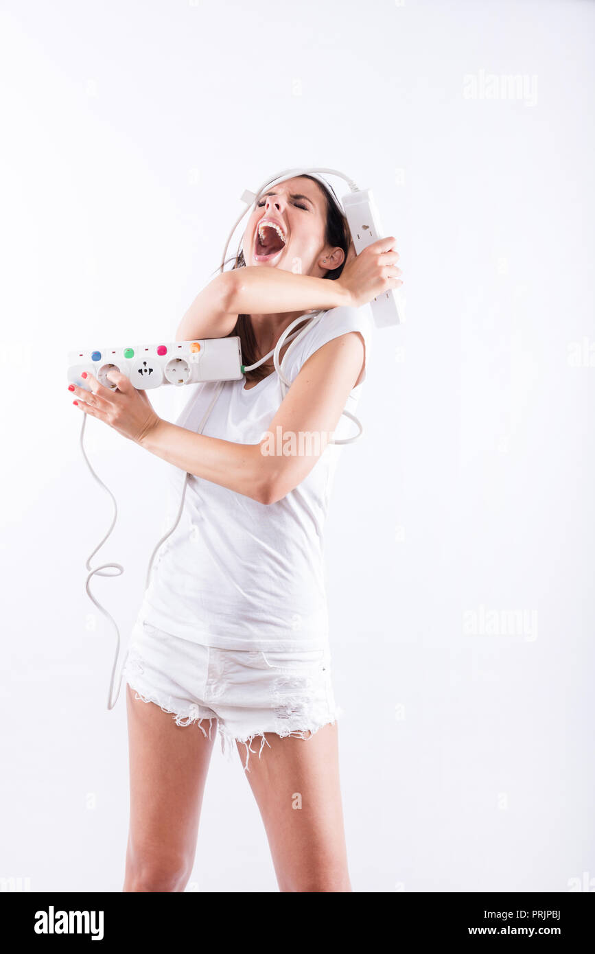 A beautiful young woman screaming with power cables in her hands Stock ...