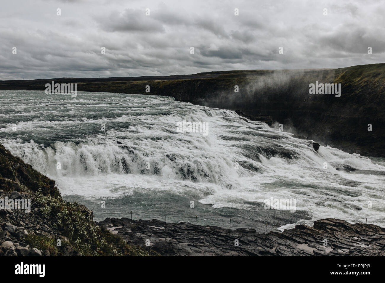 aerial view of beautiful Gullfoss waterfall under cloudy sky in Iceland ...