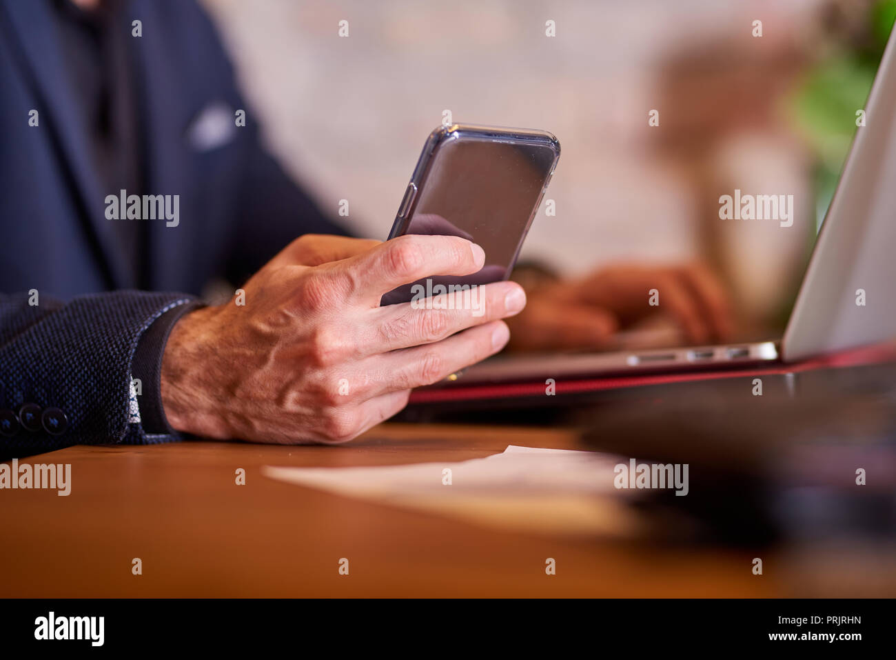Closeup view of a businessman while using a smartphone in office ...