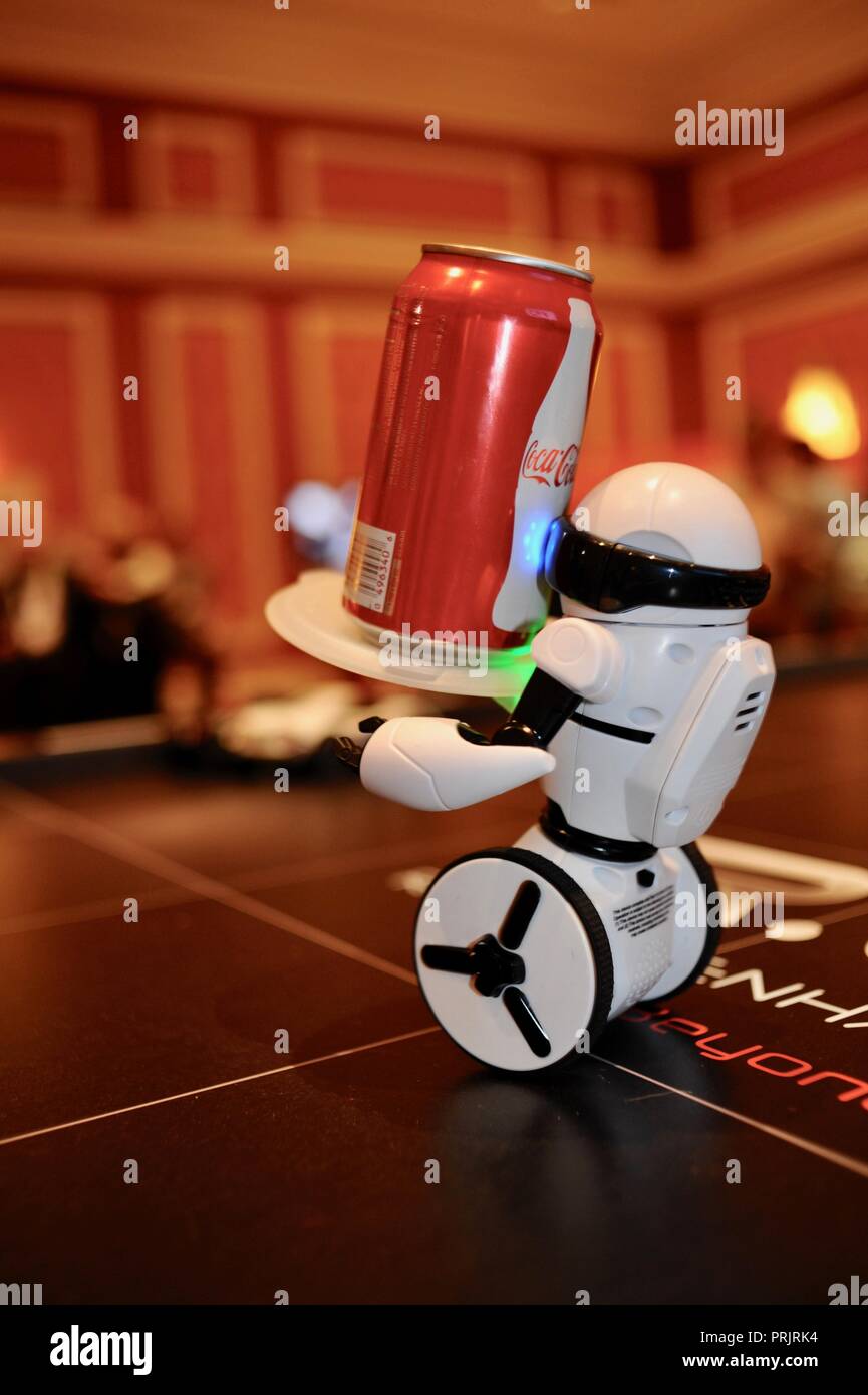 Small robot with Coca Cola on tray in demonstration, CES (Consumer ...