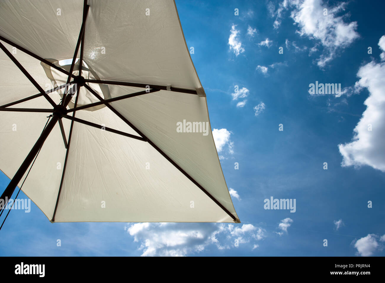 Summer parasol with blue sky and white clouds Stock Photo - Alamy
