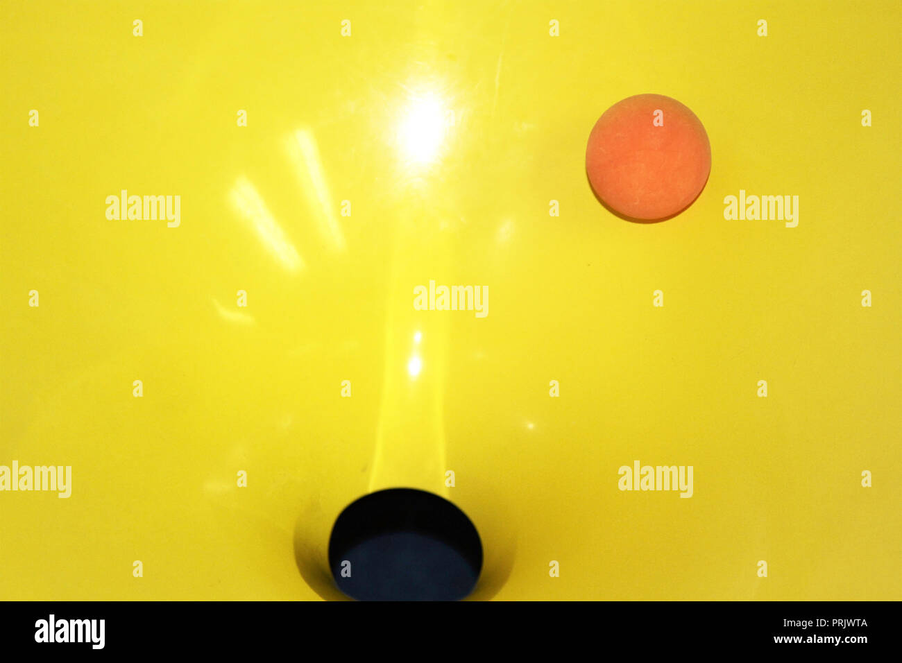 Rolling a ball into a vortex hole Stock Photo - Alamy