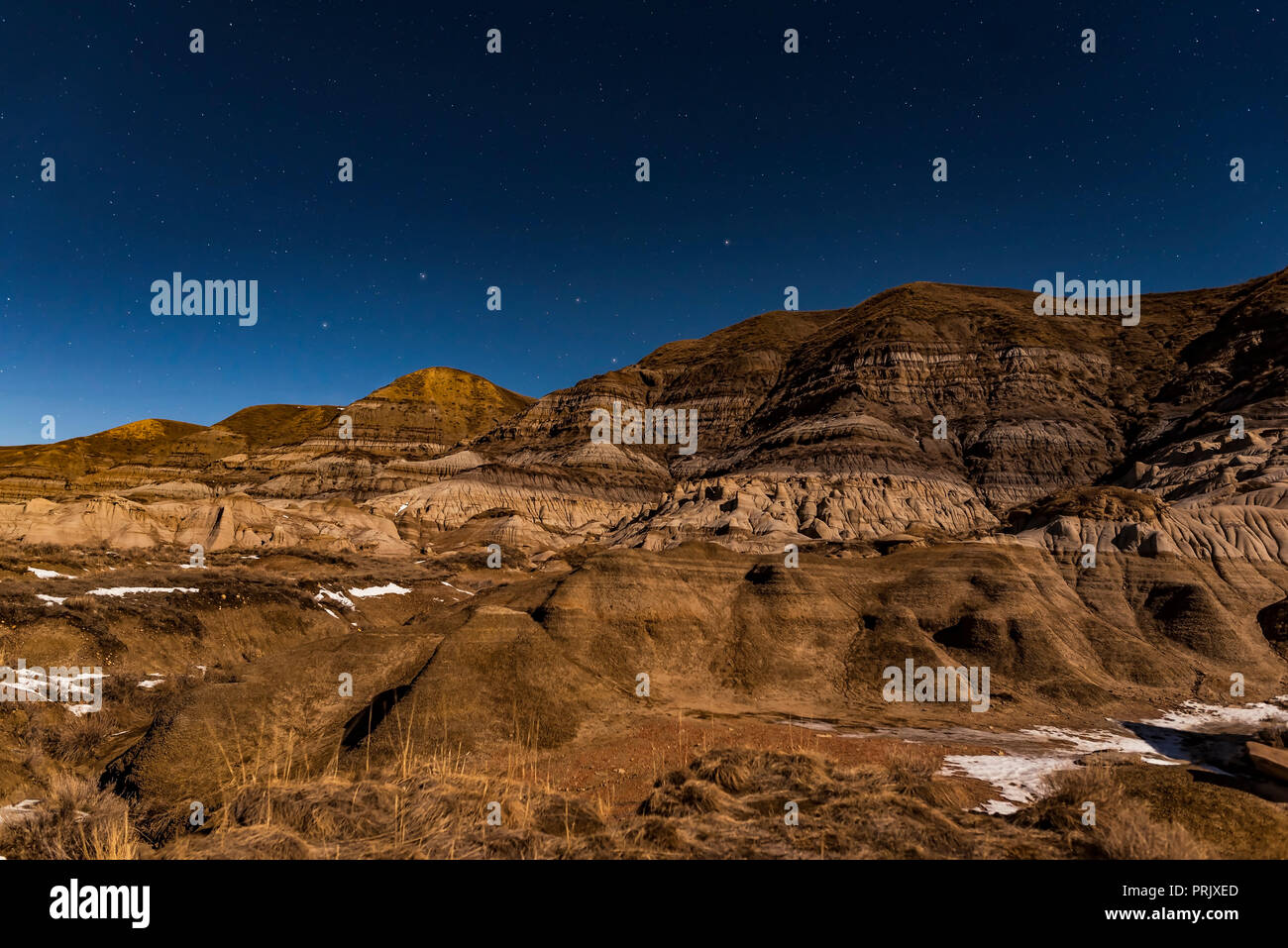 The Big Dipper dipping below the Badland hills on a late autumn or ...