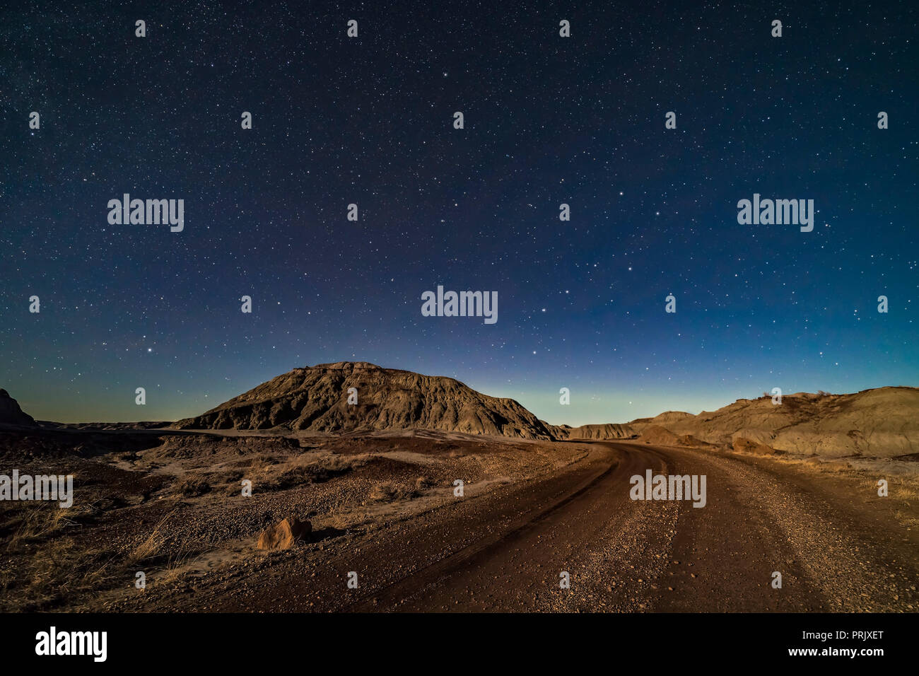 A moonlit nightscape of the badlands loop road in Dinosaur Provincial ...