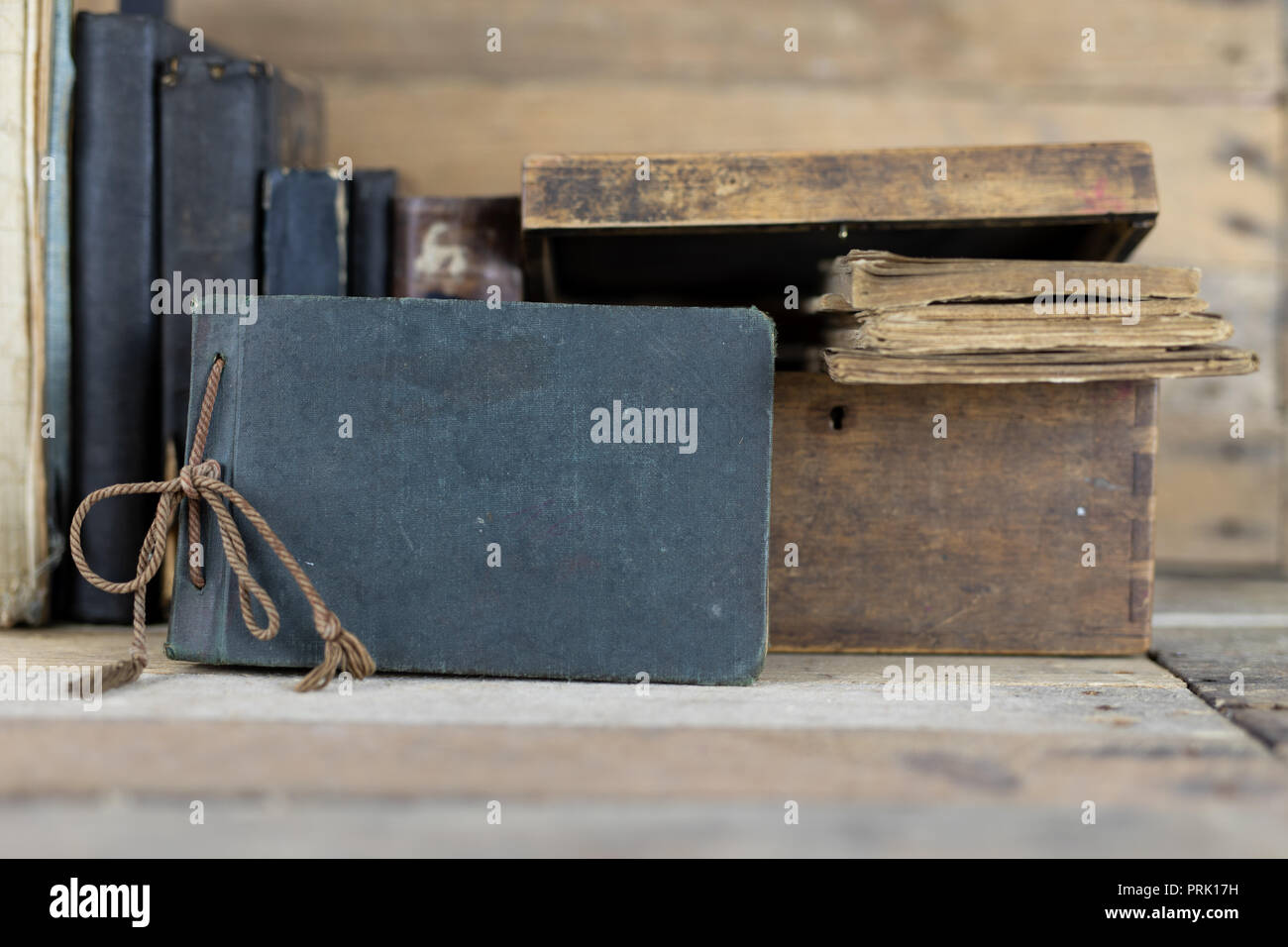 Old books and a wooden box set on a shelf. Old publishing houses set ...