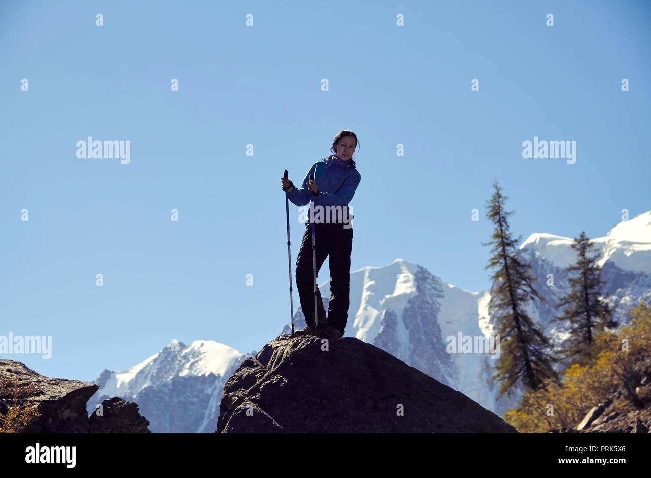 Brave girl conquering mountain peaks of the Altai mountains. The ...