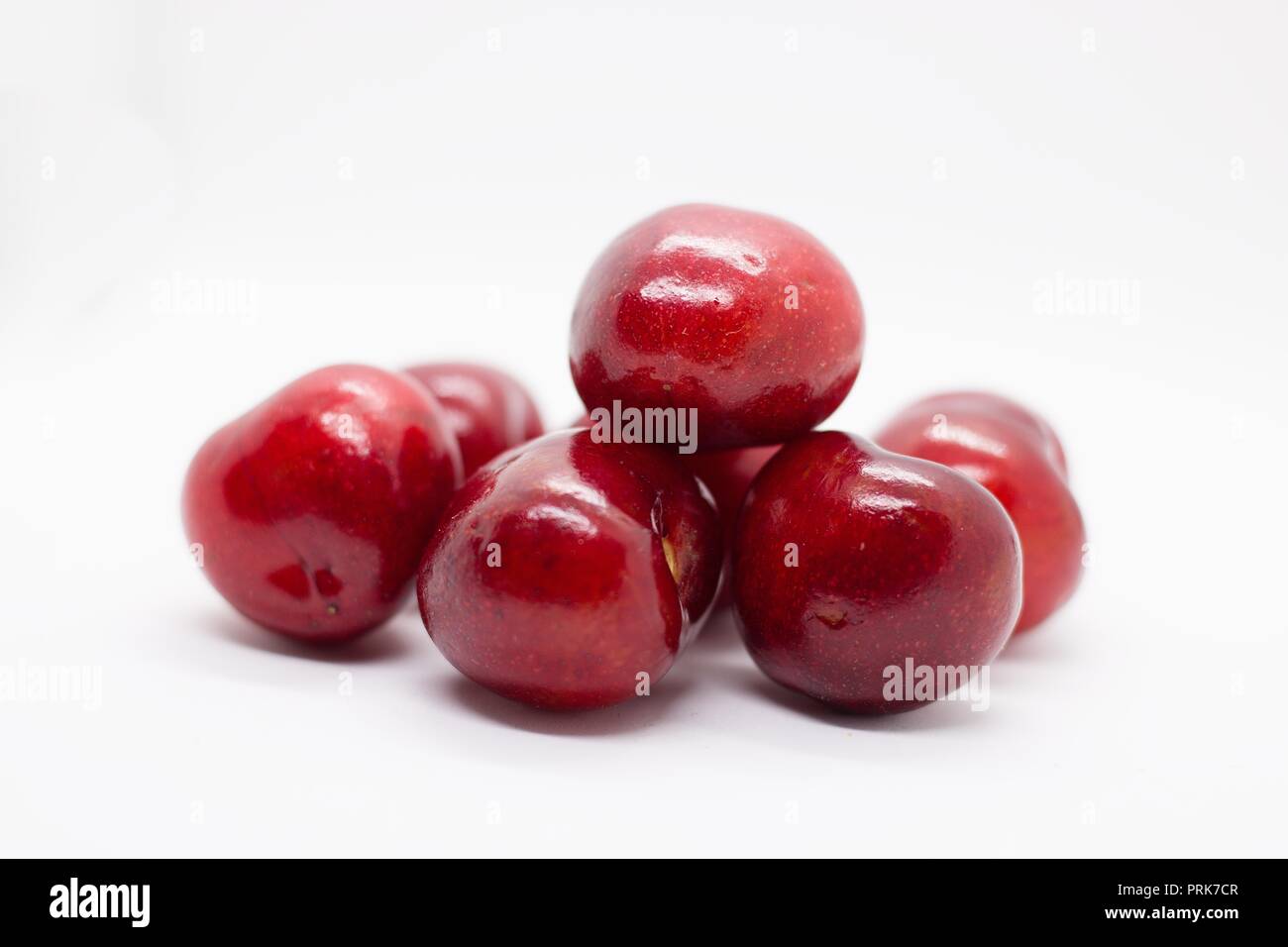 Pile of juicy red cherries isolated on white background. Side view ...