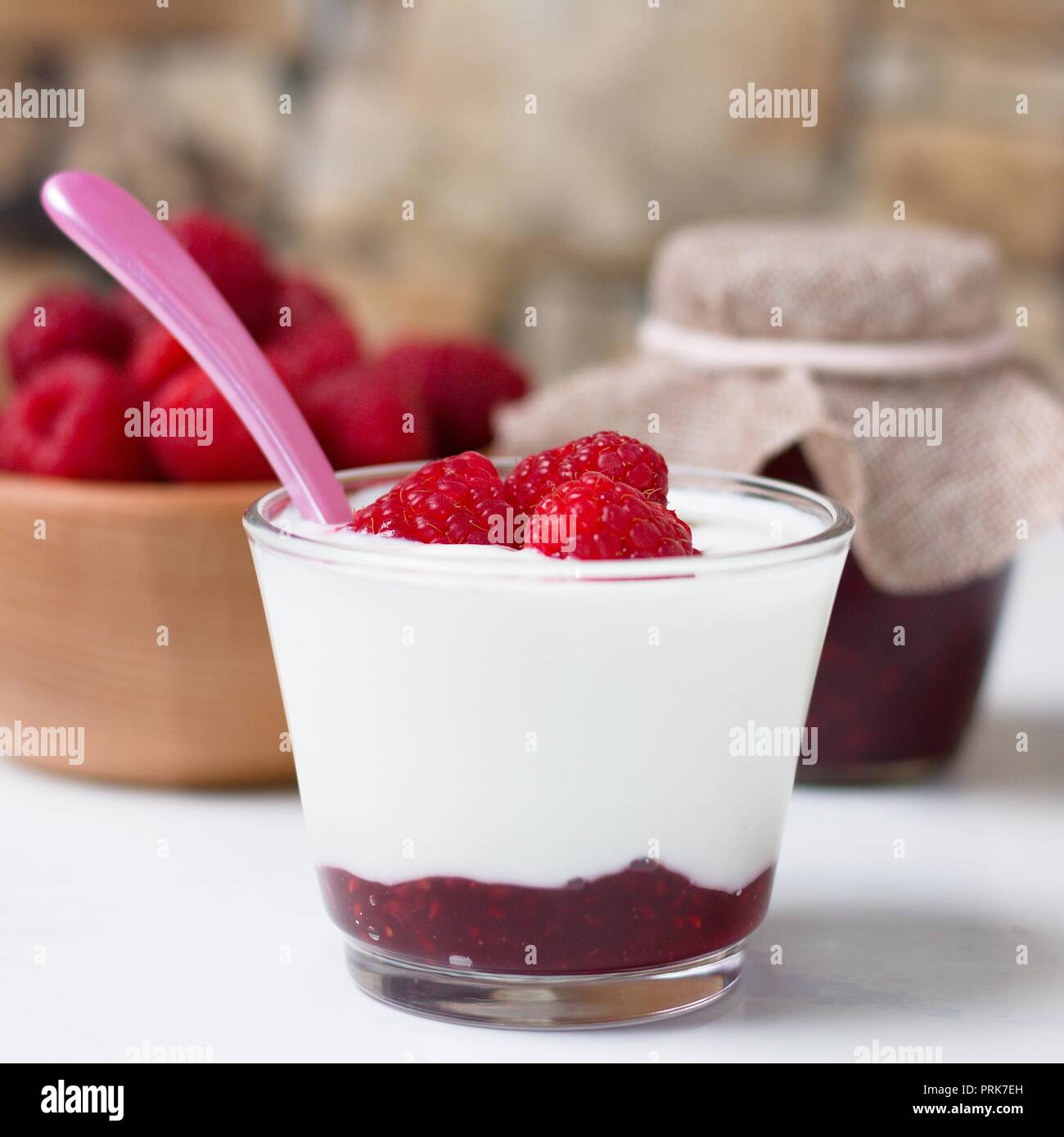 Fresh white yogurt with raspberries Stock Photo - Alamy