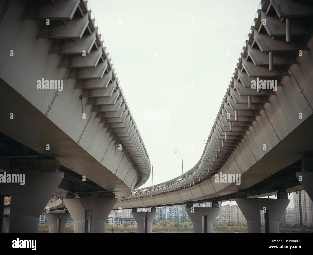 Road-bridges with columns on the background of the daytime city Stock ...