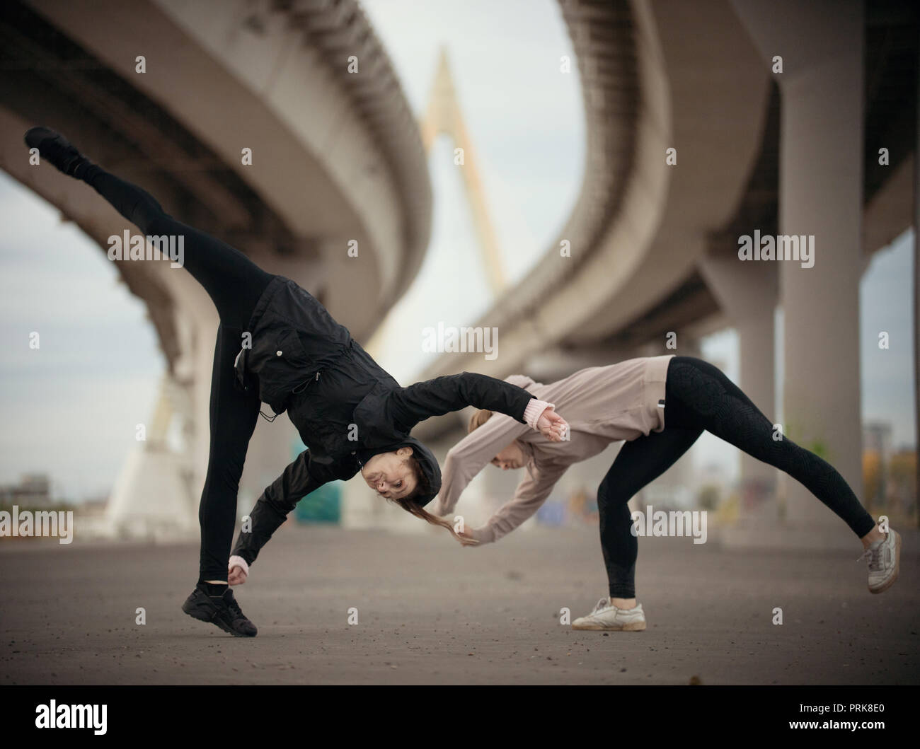 Girls begin to perform a synchronized jump in the splits on the urban ...