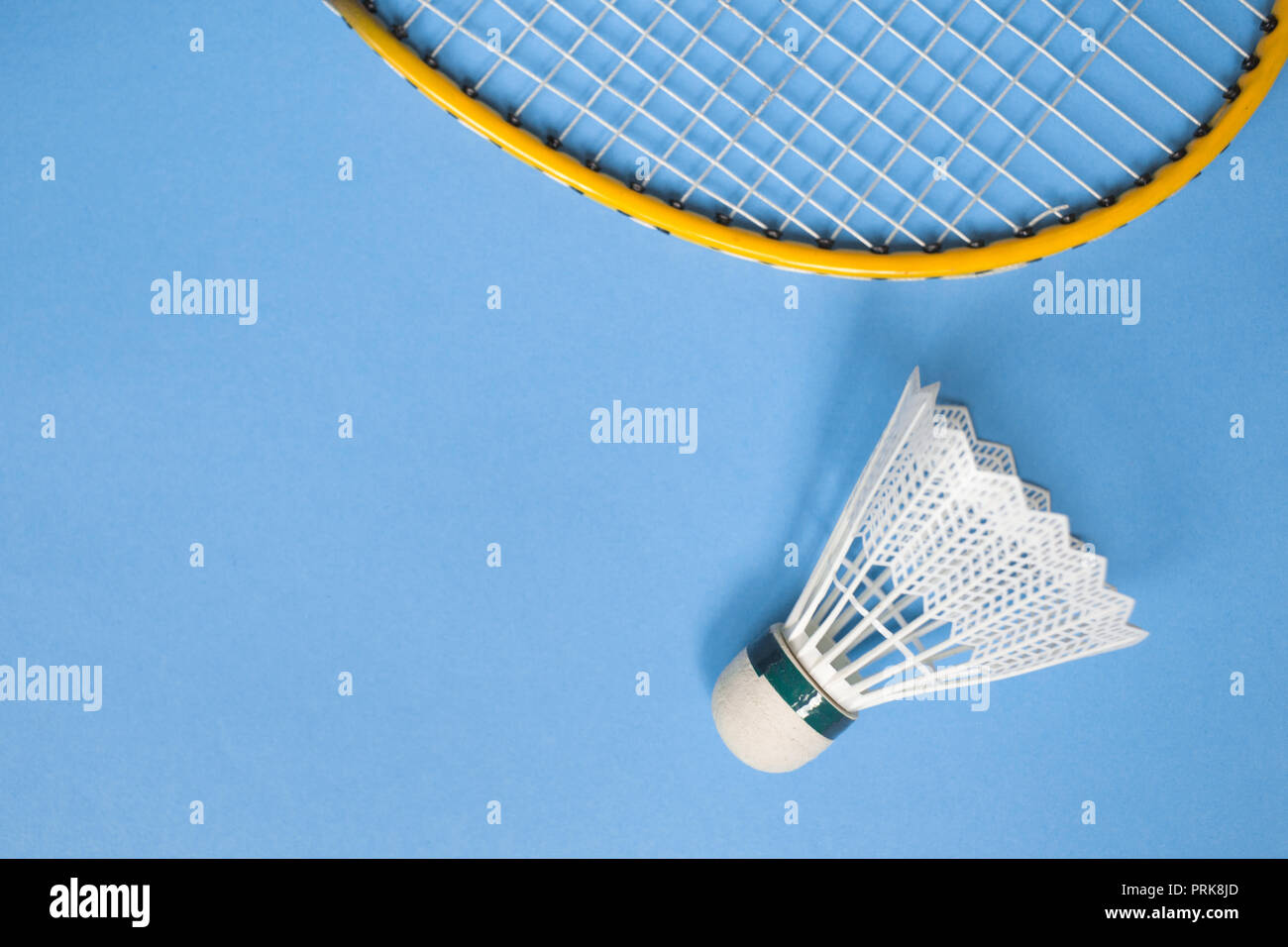 Close up shuttlecock and badminton racket on blue background Stock ...