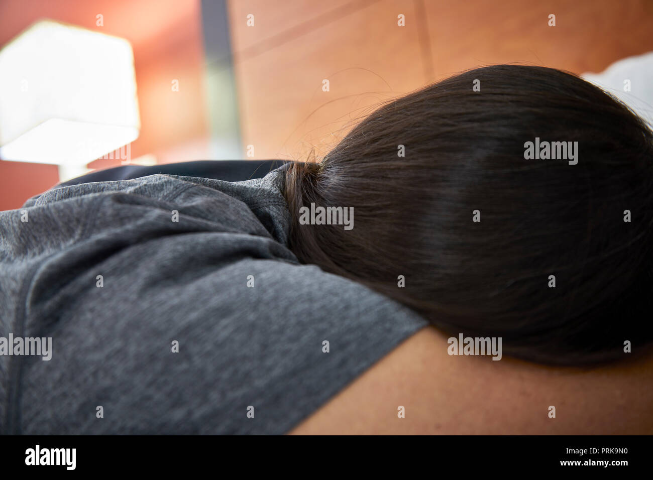 Side view of a person sleeping on a bed with shallow depth of field ...