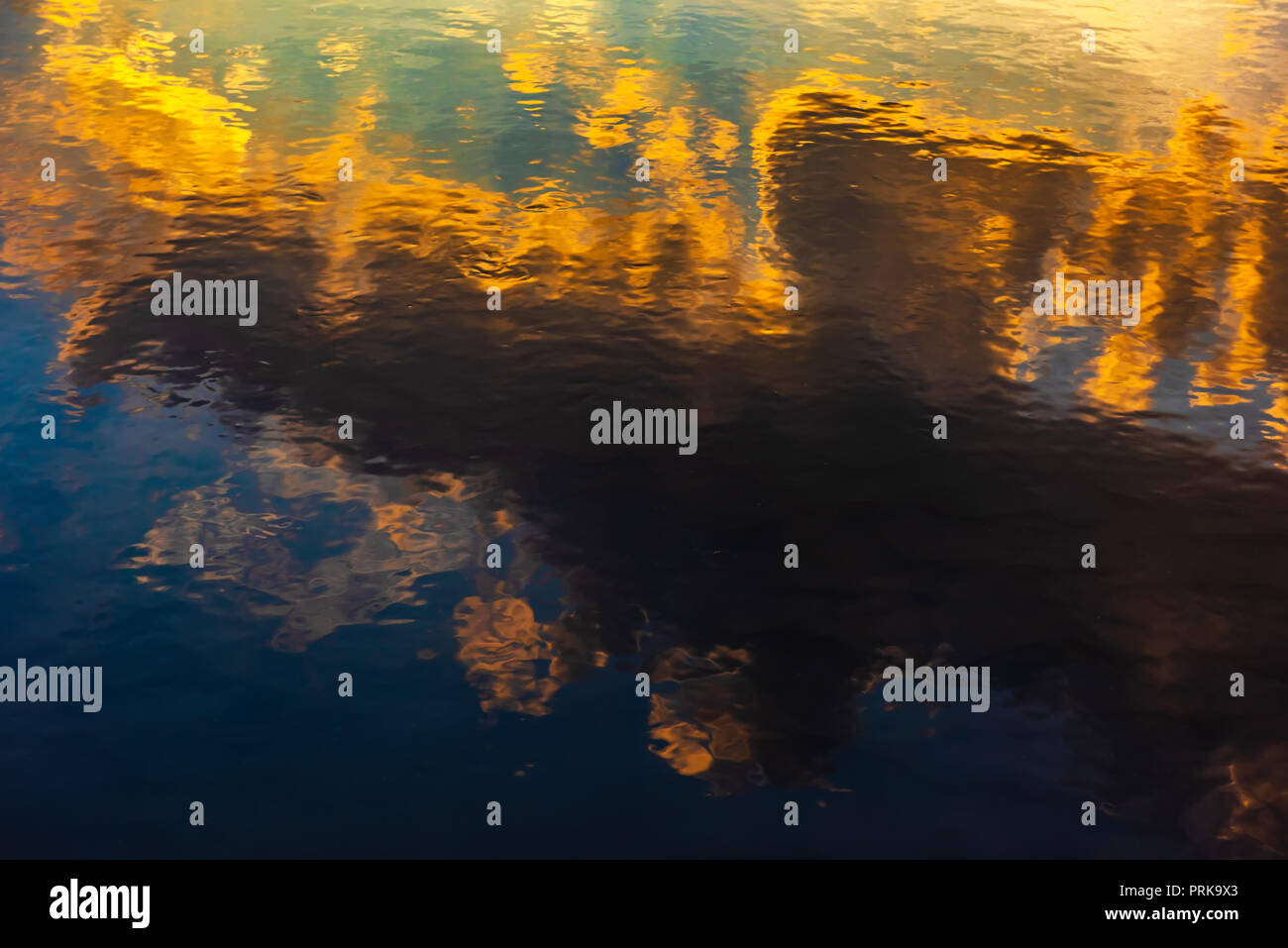 A colorful reflection of the sunset sky in the water Stock Photo - Alamy