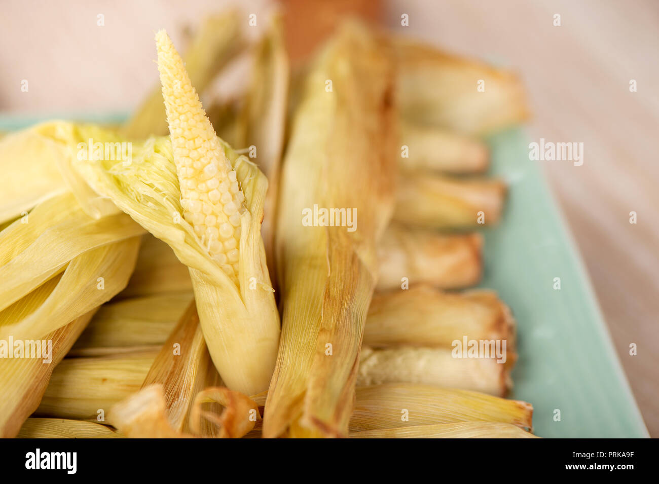 Delicious homemade izakaya-like roast baby corn in wooden background ...