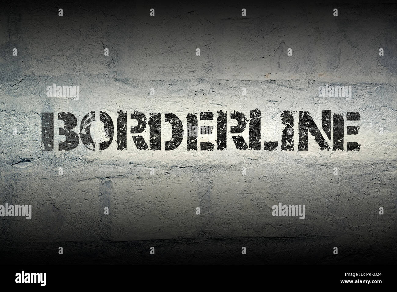 borderline stencil print on the grunge white brick wall Stock Photo - Alamy