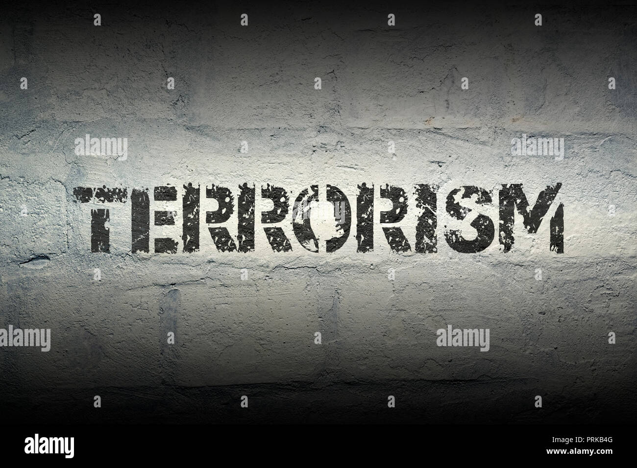 terrorism stencil print on the grunge white brick wall Stock Photo - Alamy