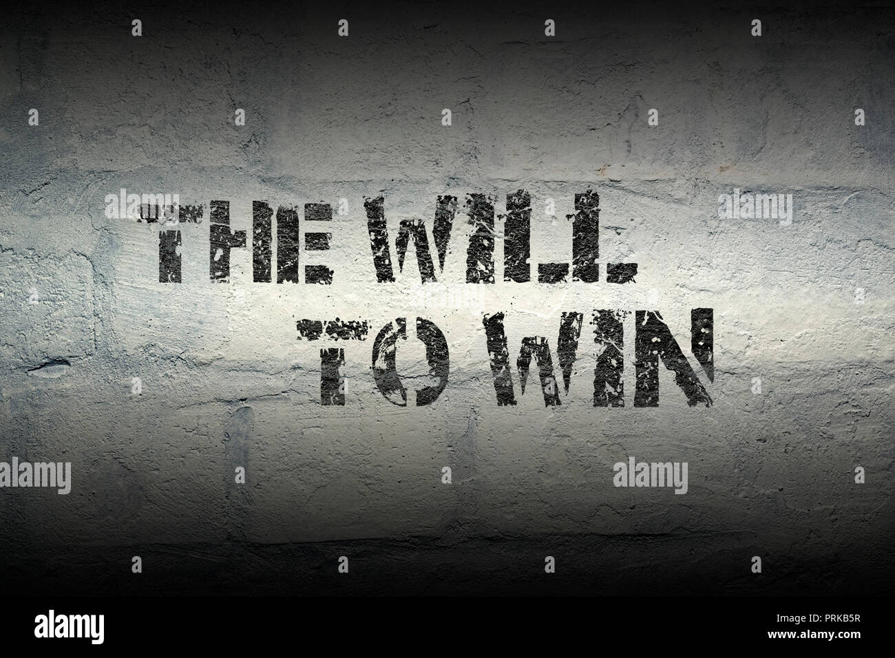 will to win phrase stencil print on the grunge white brick wal Stock ...