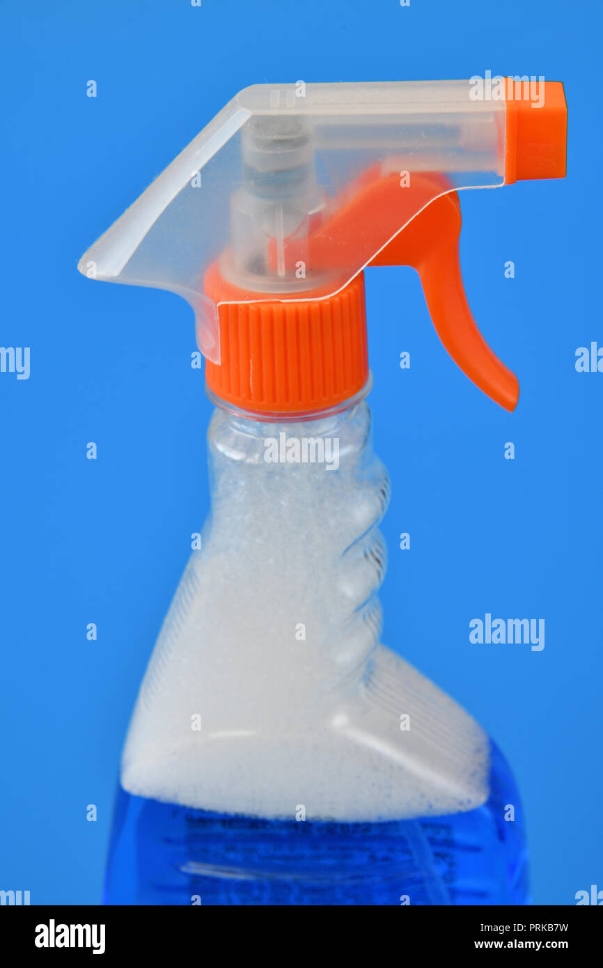 spray bottle with cleaning agents on a blue background Stock Photo - Alamy