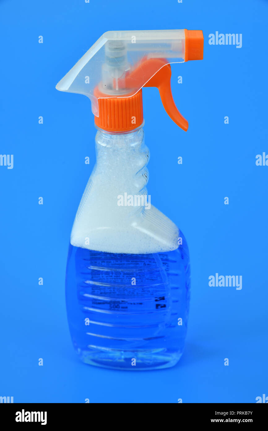 spray bottle with cleaning agents on a blue background Stock Photo - Alamy