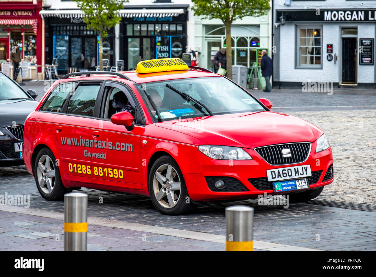 CAERNARFON / WALES - MAY 01 2018 : Taxis on a windy day Stock Photo - Alamy