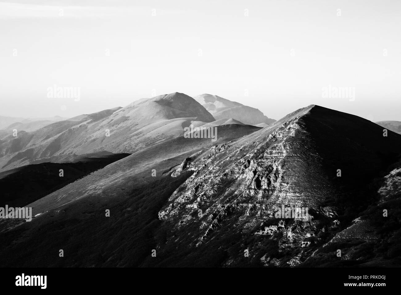 A view of some mountains top, beneath an empty sky Stock Photo - Alamy