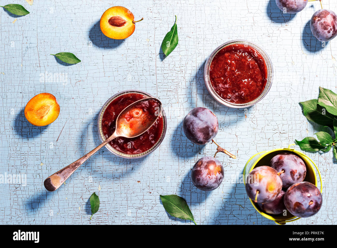 Plum jam on the old blue wood background Stock Photo - Alamy